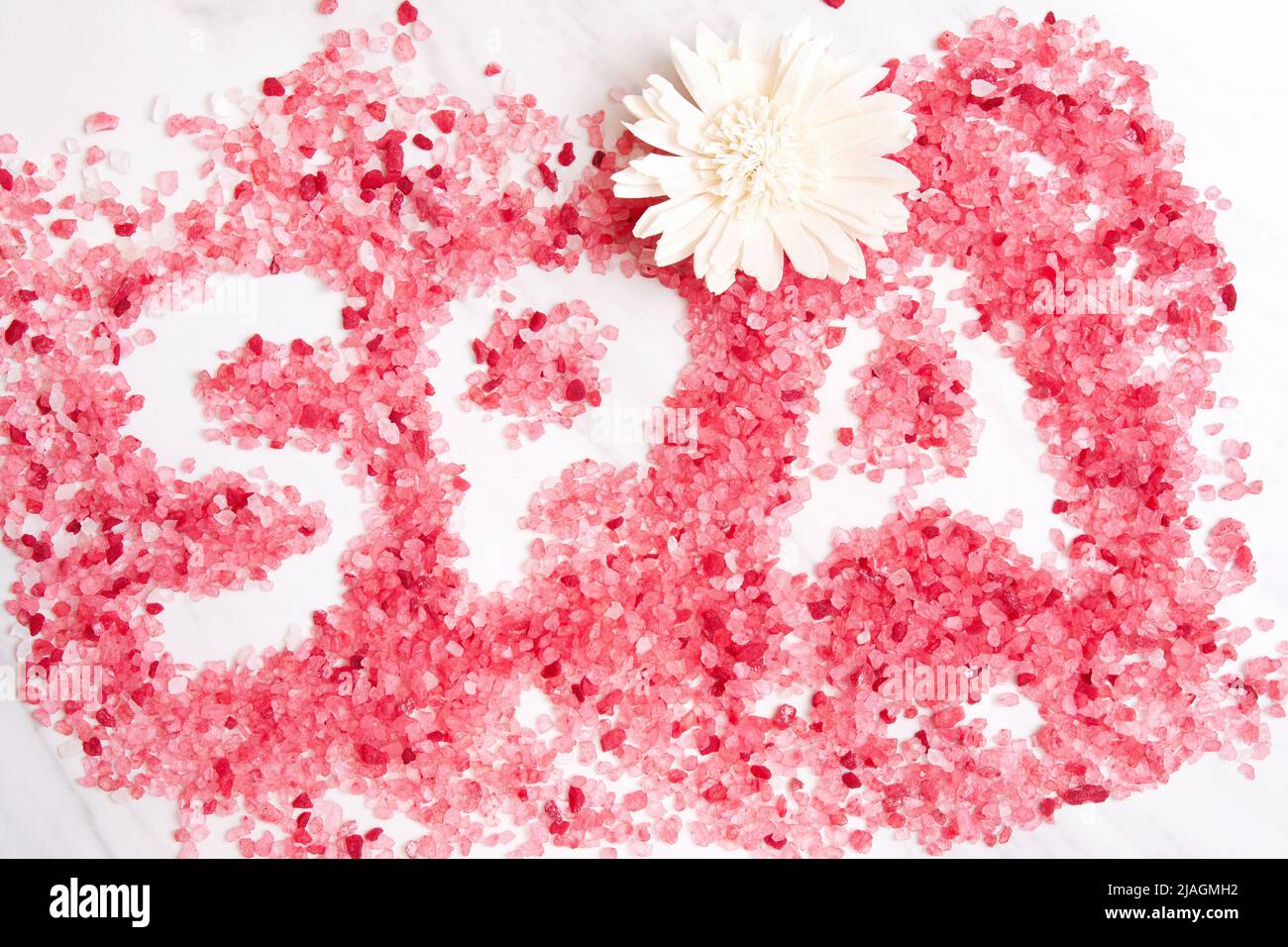 The word SPA is laid out from bath salts on a marble table. Beauty ...