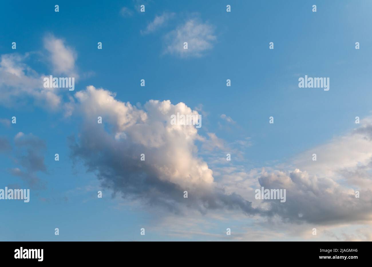 Fluffy clouds in spring blue sky. Sunlight on white clouds Stock Photo ...