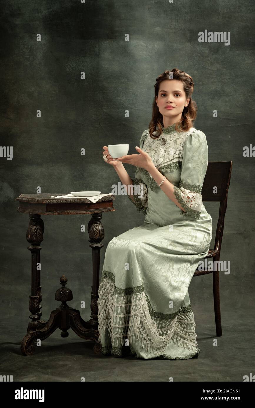 Vintage portrait of young beautiful girl in gray dress of medieval ...
