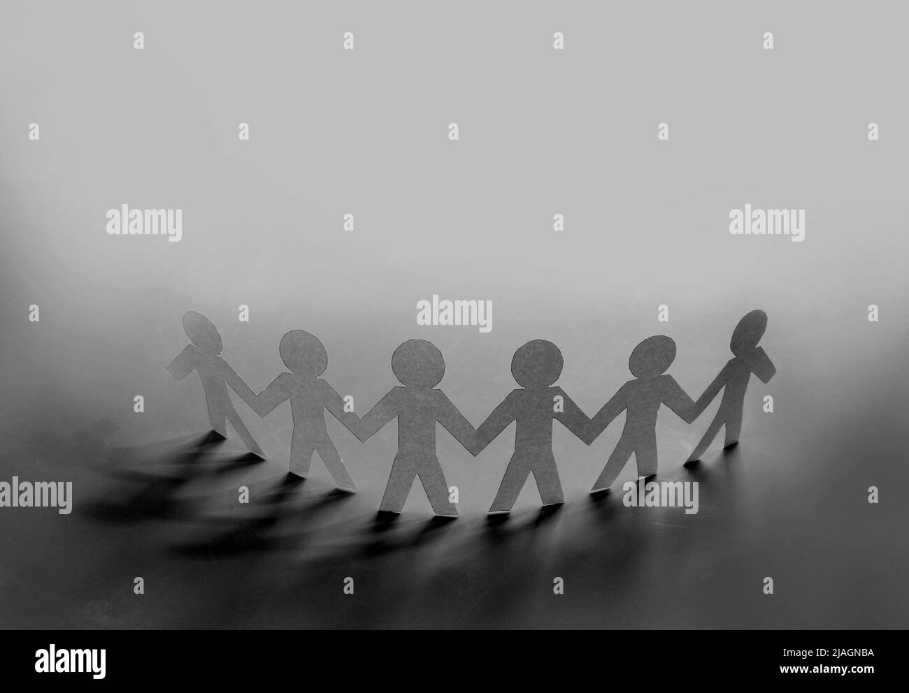 Paper people doing teamwork in their business Stock Photo - Alamy