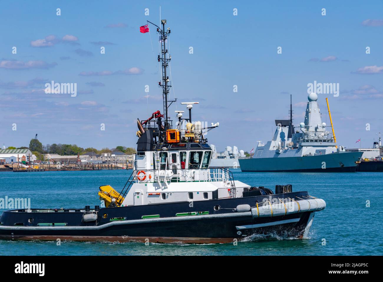 Harbor tug and a Royal Navy warship (D34 HMS Diamond) in the Naval ...
