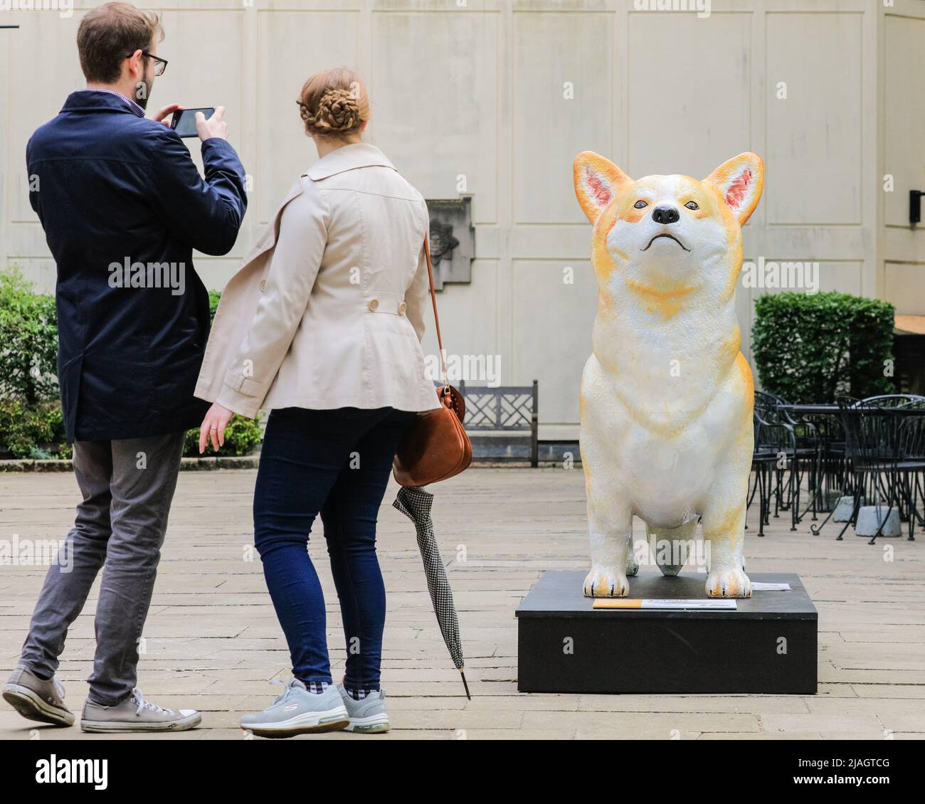 London, UK. 30th May, 2022. People look at and take photos of one of ...