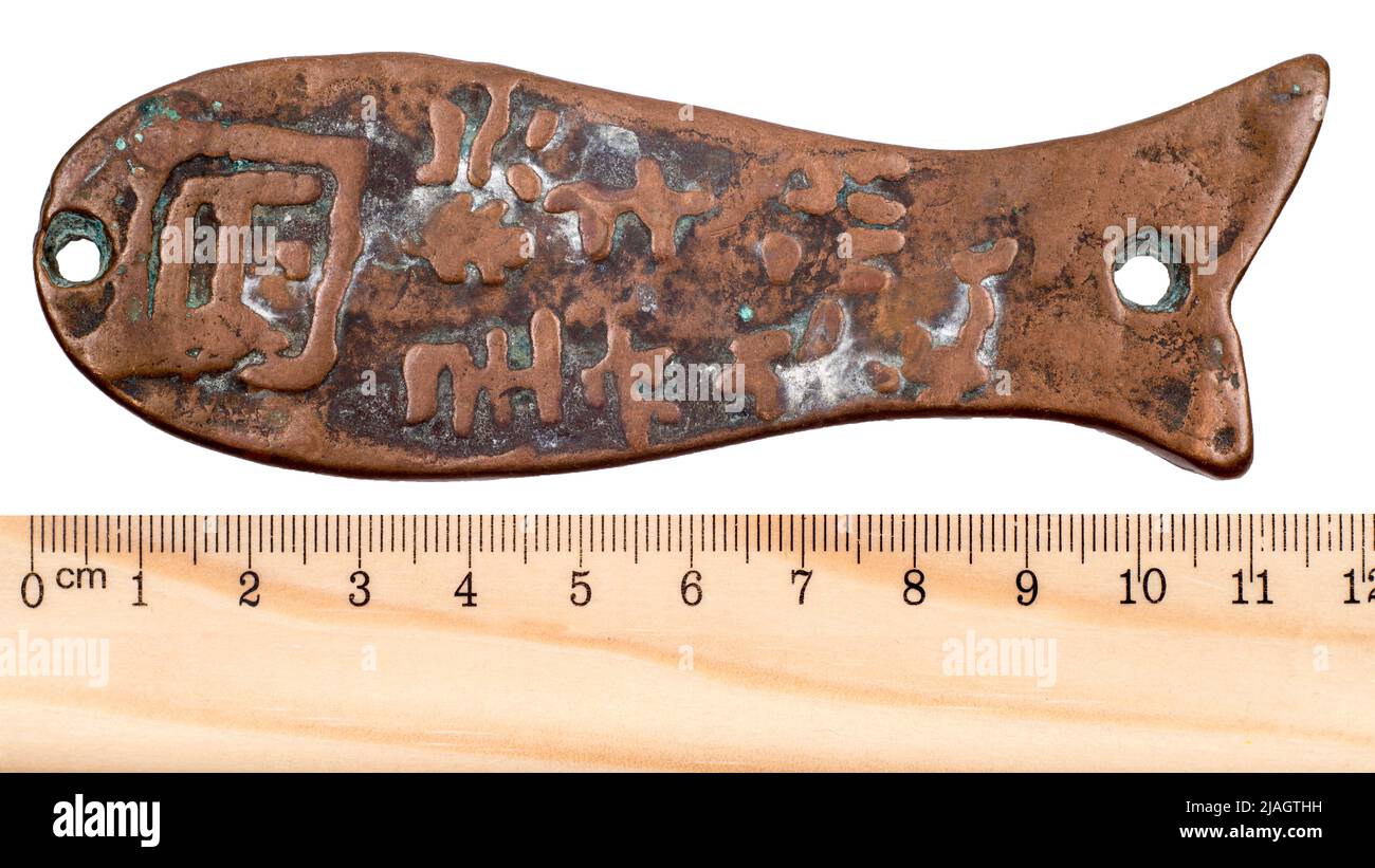 Ancient copper coin in the form of fish. Liao dynasty. China. Isolated ...
