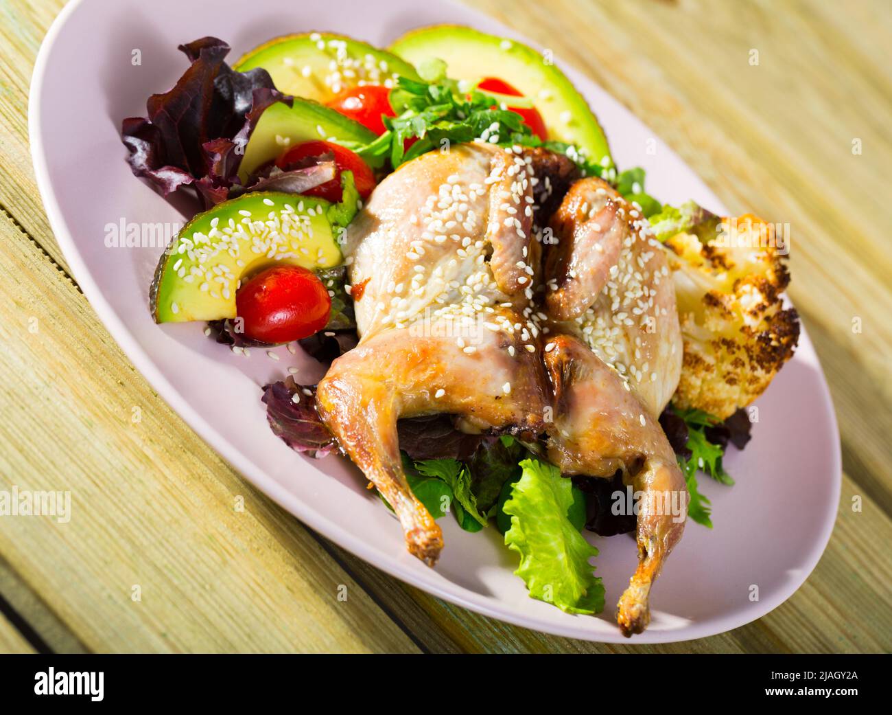 Quail Tabaka (grilled) with sesame Stock Photo - Alamy
