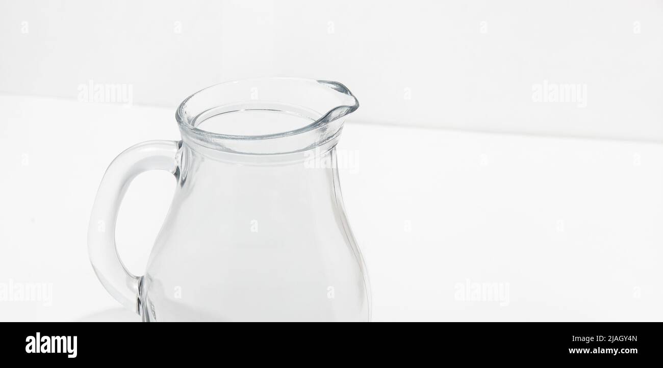 Side view of glass water jug on white background. Space for text, for ...