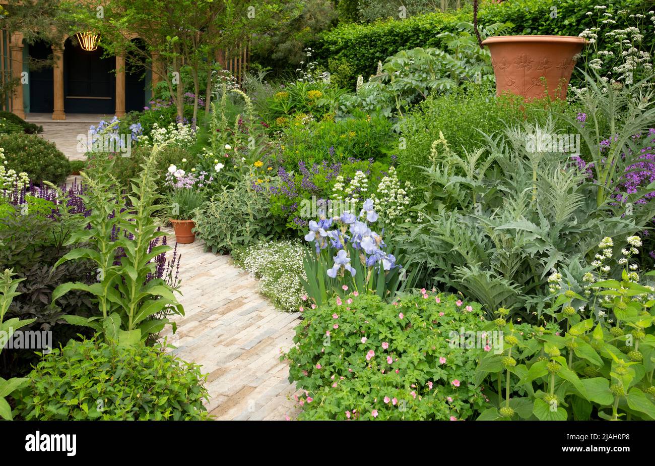 A classical style oak pavilion surrounded by lush herbaceous borders ...