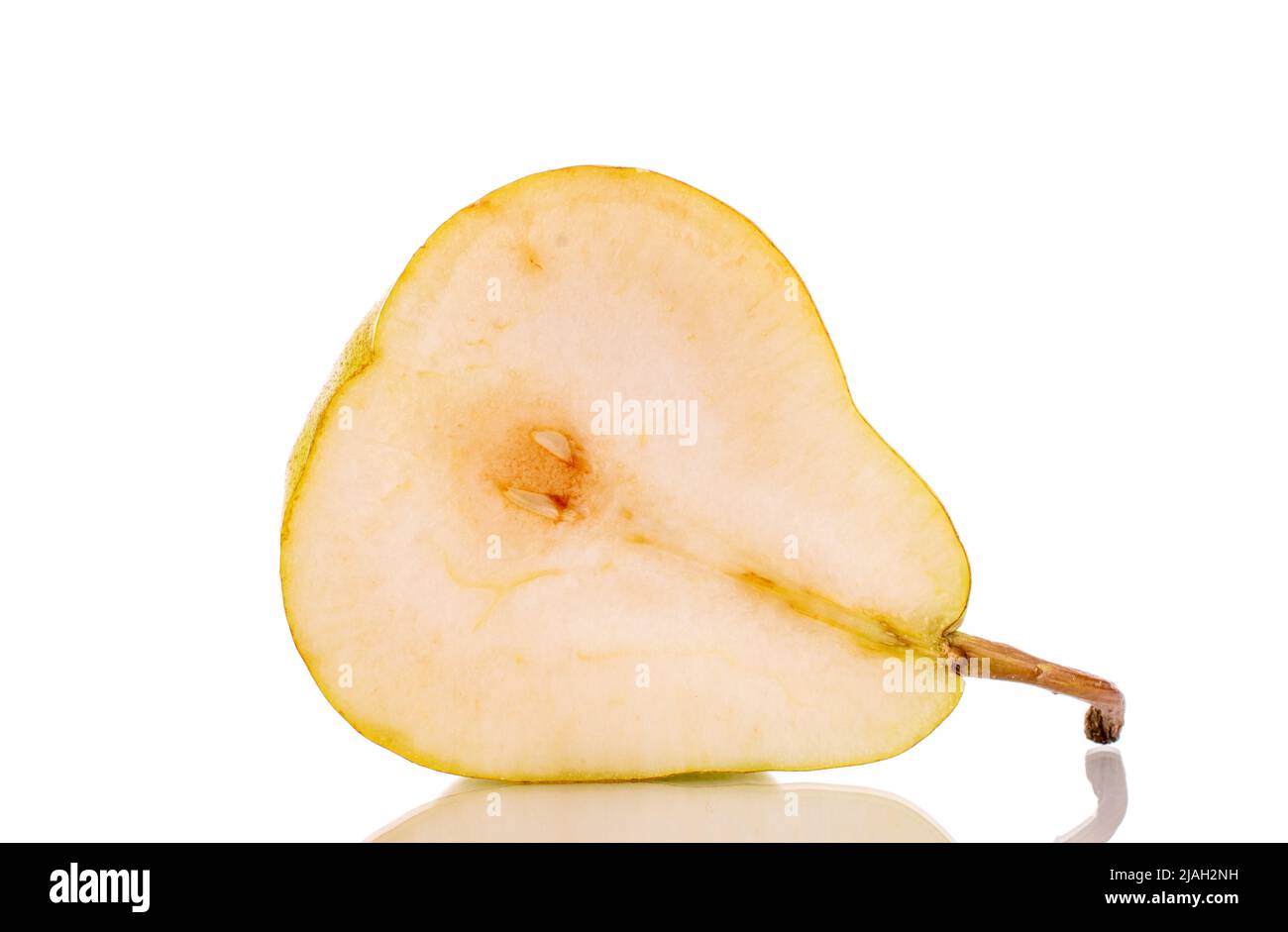 One half of a juicy yellow pear, close-up, isolated on a white ...