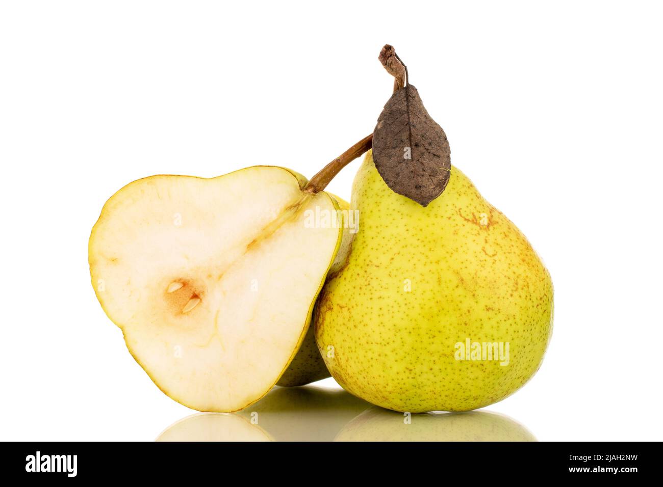 One half of a juicy yellow pear and one whole pear, close-up, isolated ...