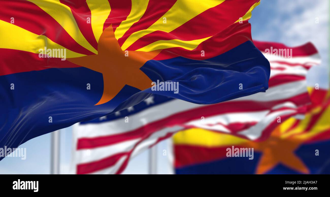 The flags of the Arizona state and United States waving in the wind. is ...