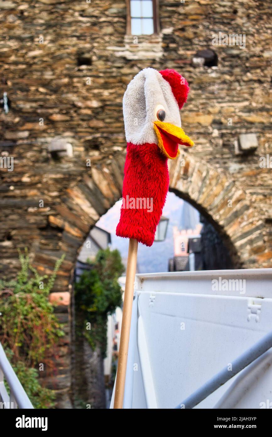 Chicken hand puppet on a stick in front of a towe in Bacharach, Germany ...