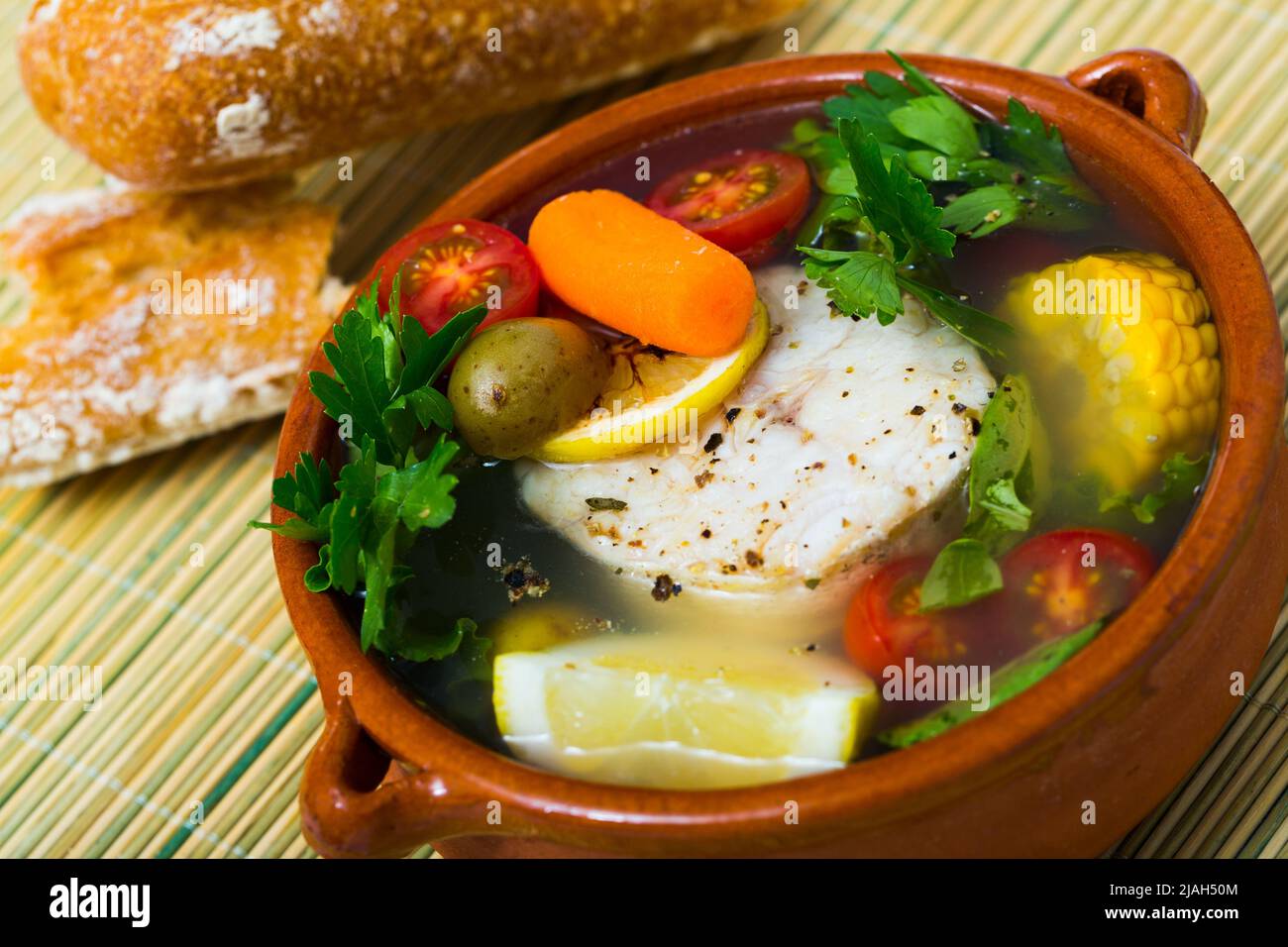 Fisherman's soup cooked with boiled pollock, carrots, corn and greens ...