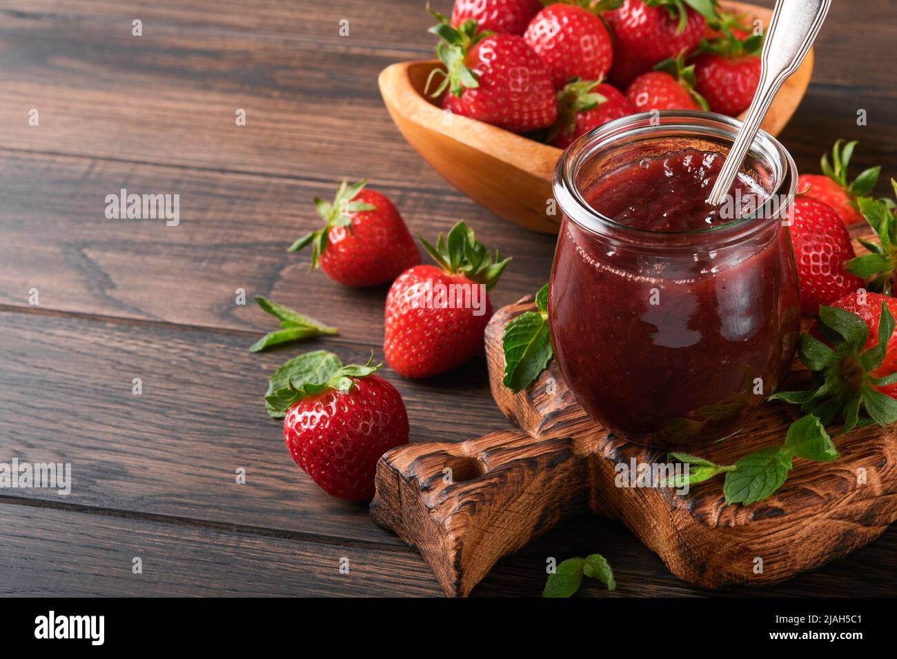 Strawberry jam. Strawberry jam in glass jar with fresh berries plate on ...