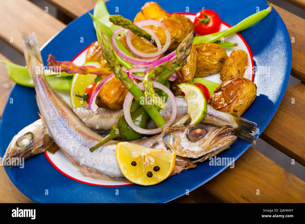 Blue Whiting fish with roasted potatoes Stock Photo - Alamy
