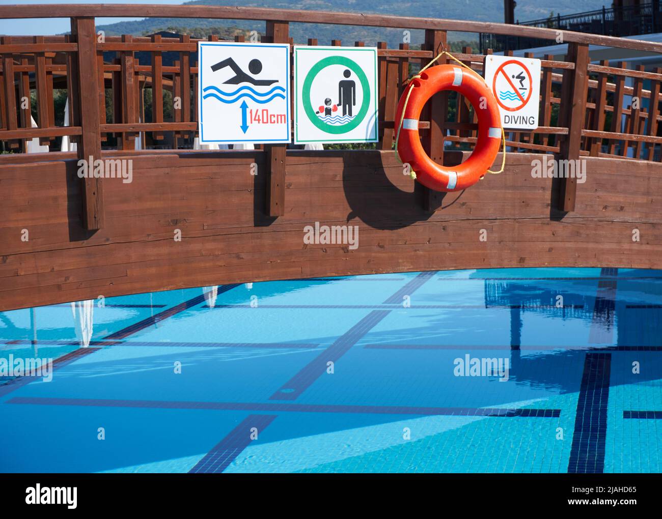 Lifebuoy, pool dept and no diving signs next to each other Stock Photo ...