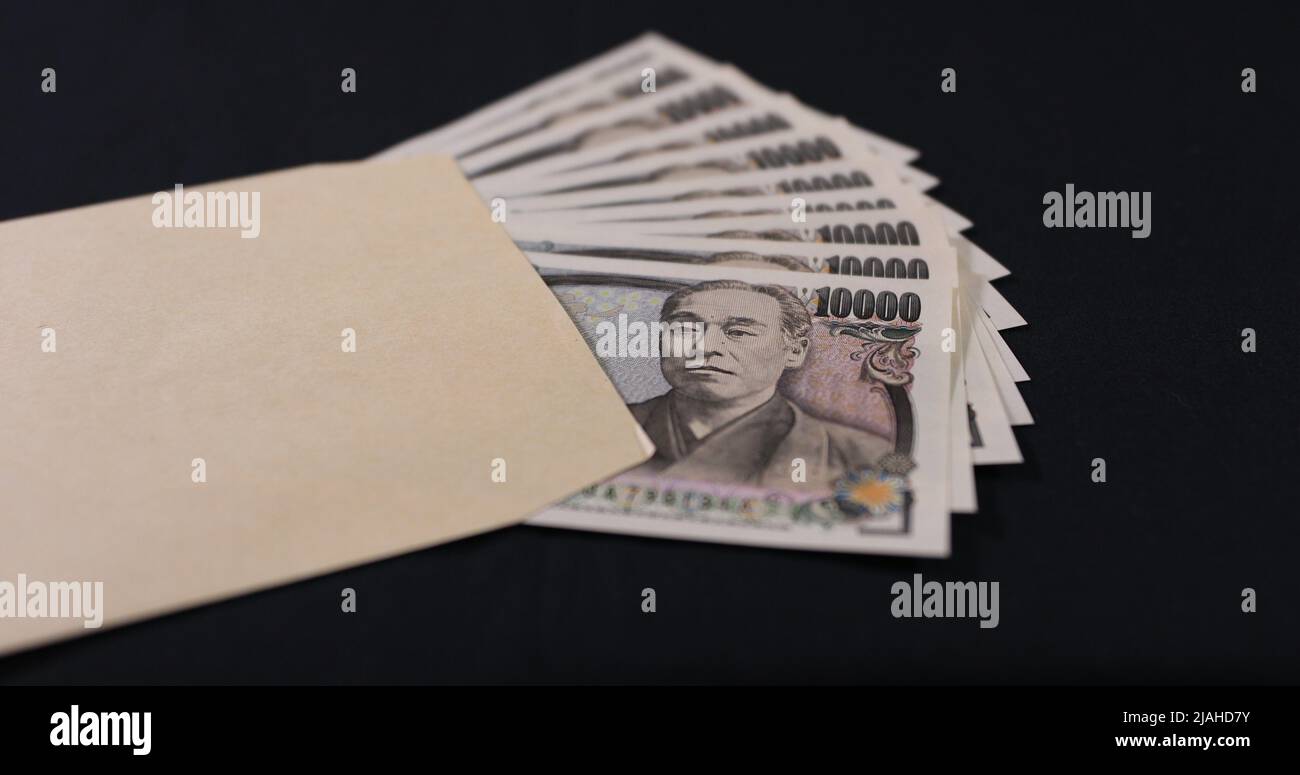 Japanese currency 100,000 yen with envelope on the black background ...