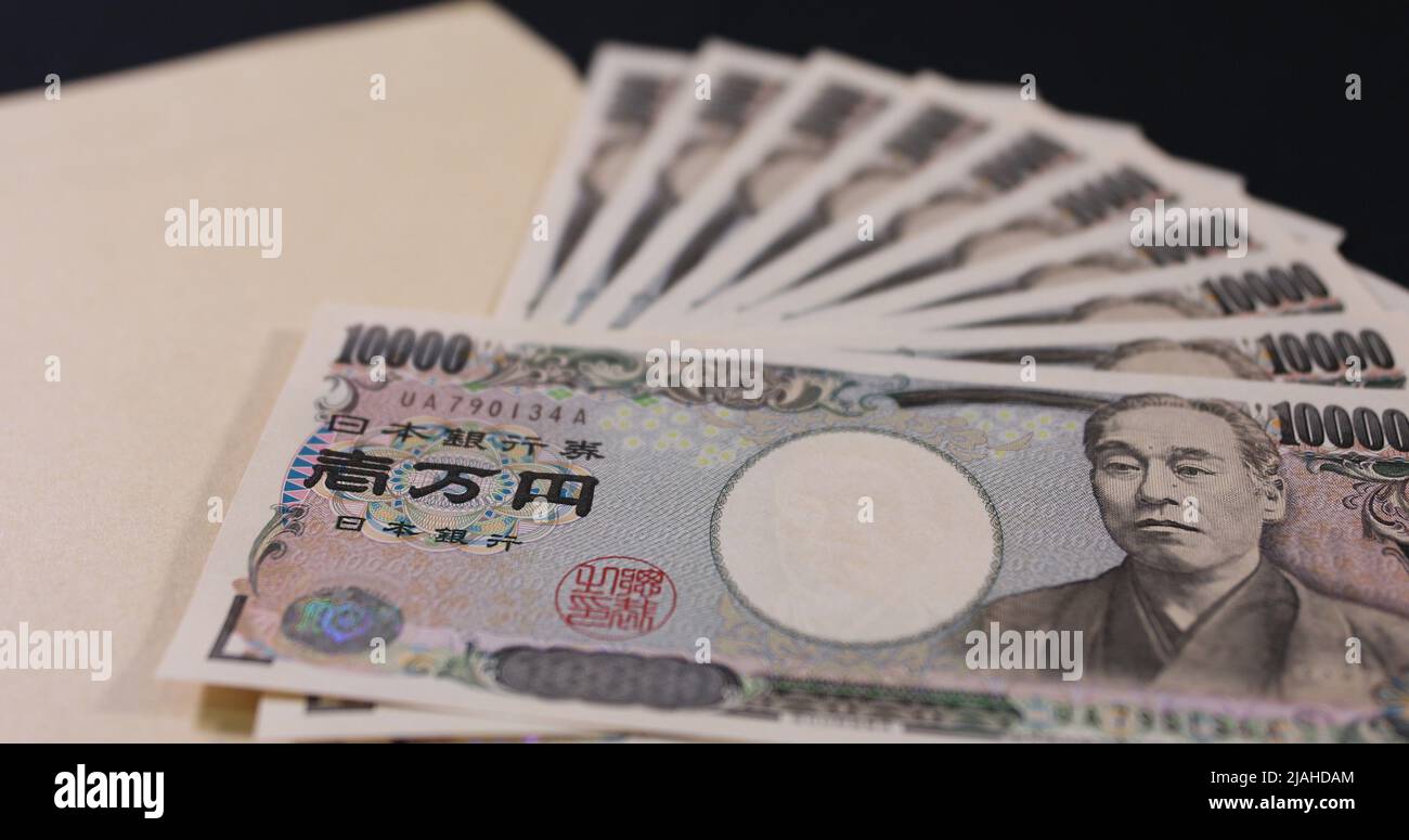 Japanese currency 100,000 yen with envelope on the black background ...