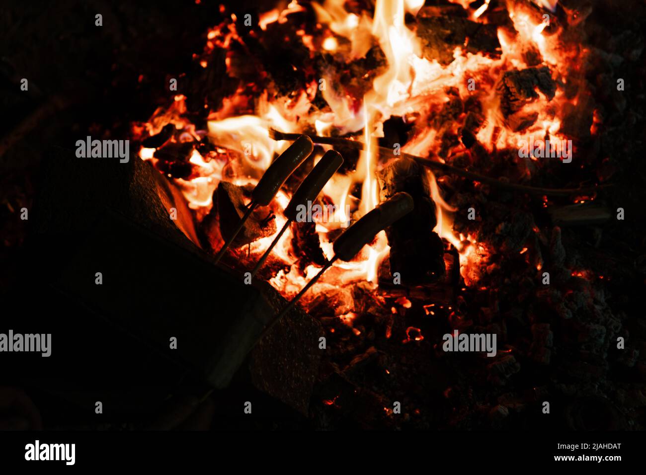 A campfire with sparks at night dark. Orange flame outdoor Stock Photo ...