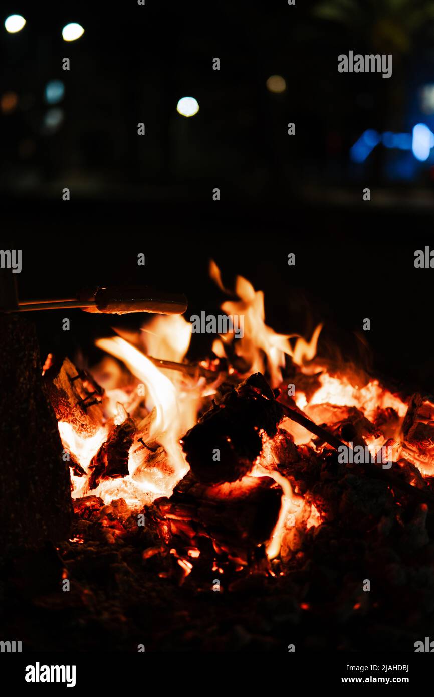 A campfire with sparks at night dark. Orange flame outdoor Stock Photo ...