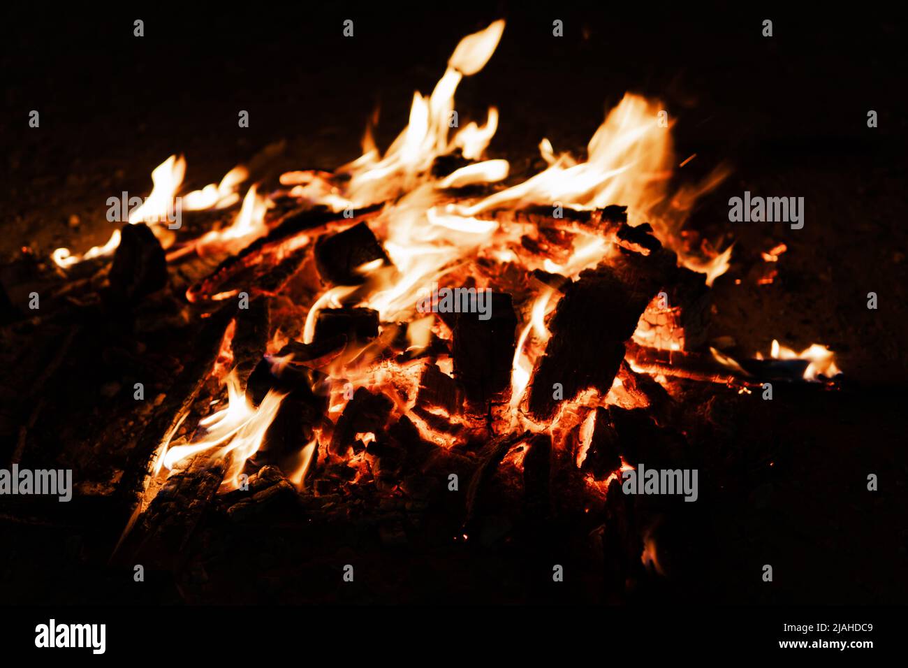 A campfire with sparks at night dark. Orange flame outdoor Stock Photo ...