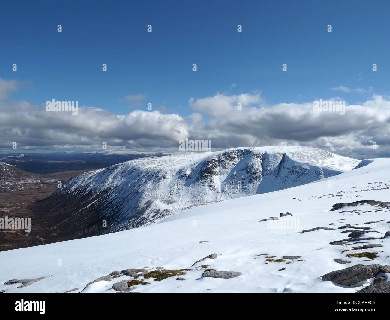 View of the corniced & snow covered Munro, Beinn Bhrotain, & down Glen ...