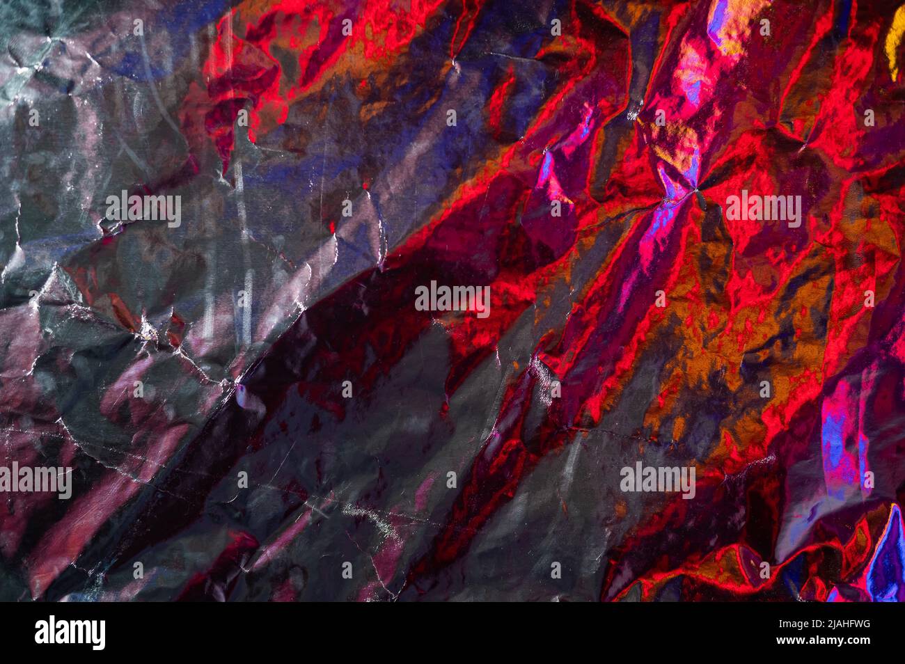 Color foil in neon light. Silver red wallpaper Stock Photo - Alamy