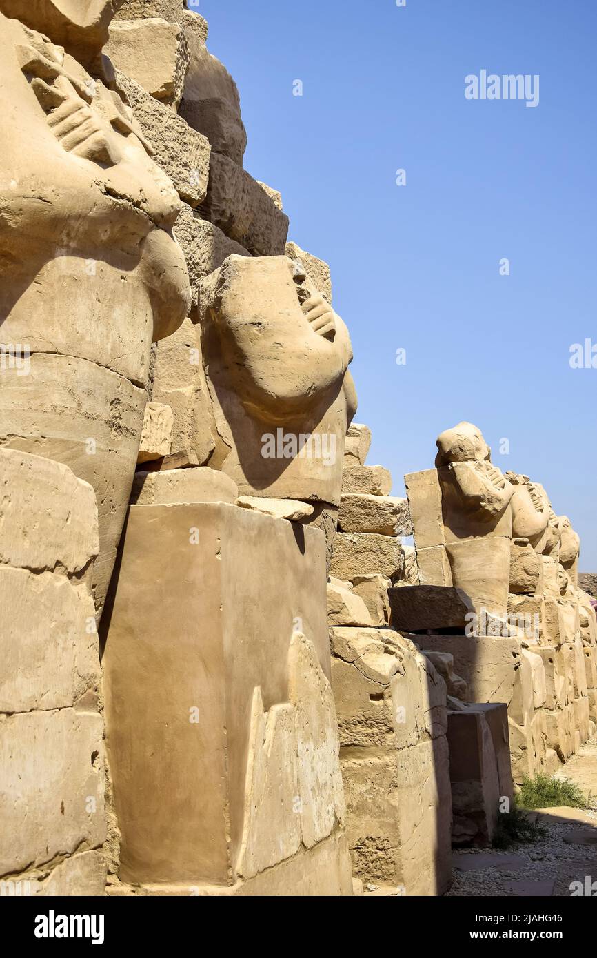 Ruins of Karnak Temple complex with sculptures, statues and columns ...