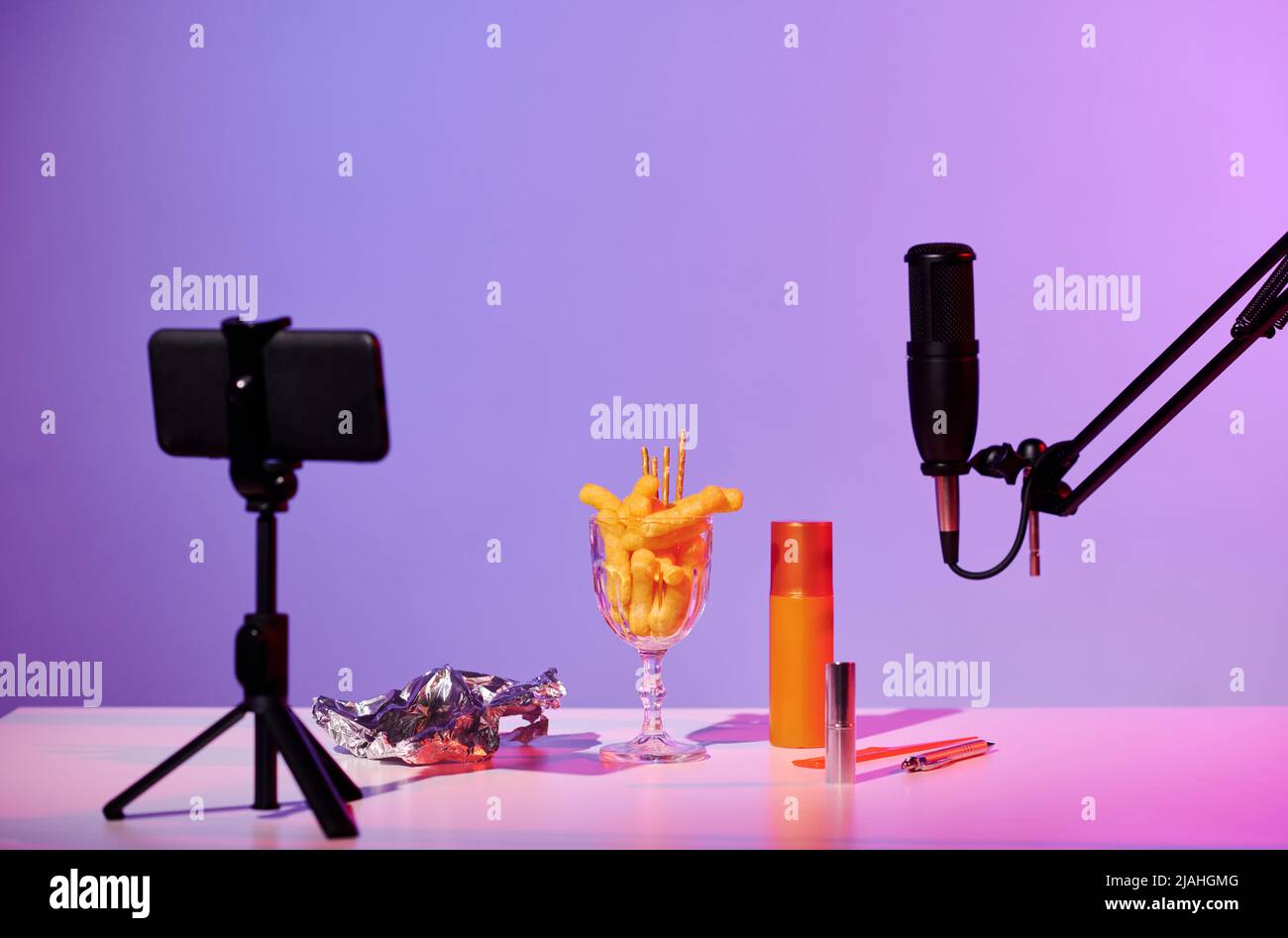 No people still life shot of microphone, smartphone on tripod, glass ...