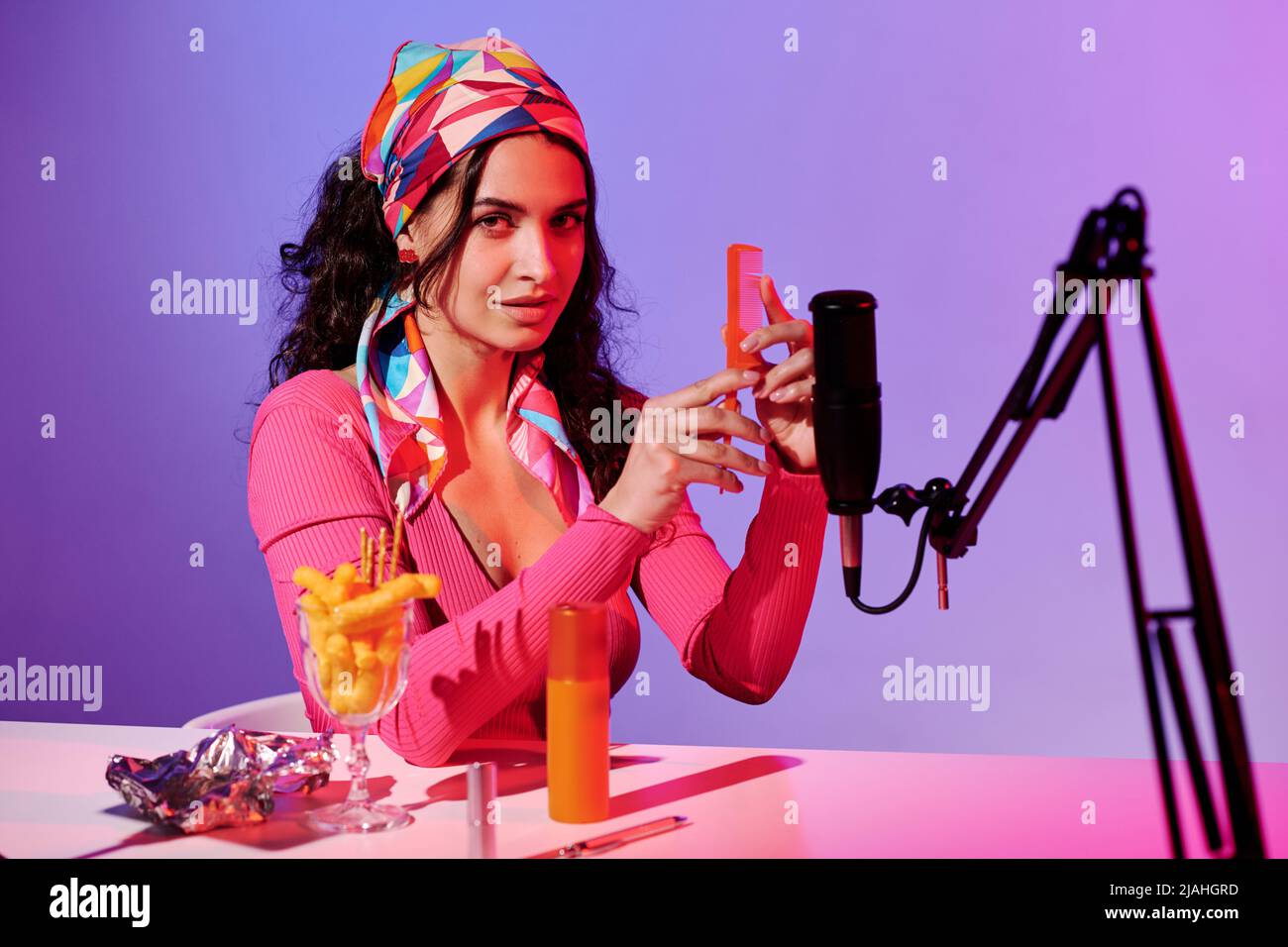 Stylish young Caucasian woman creating ASMR content recording ...