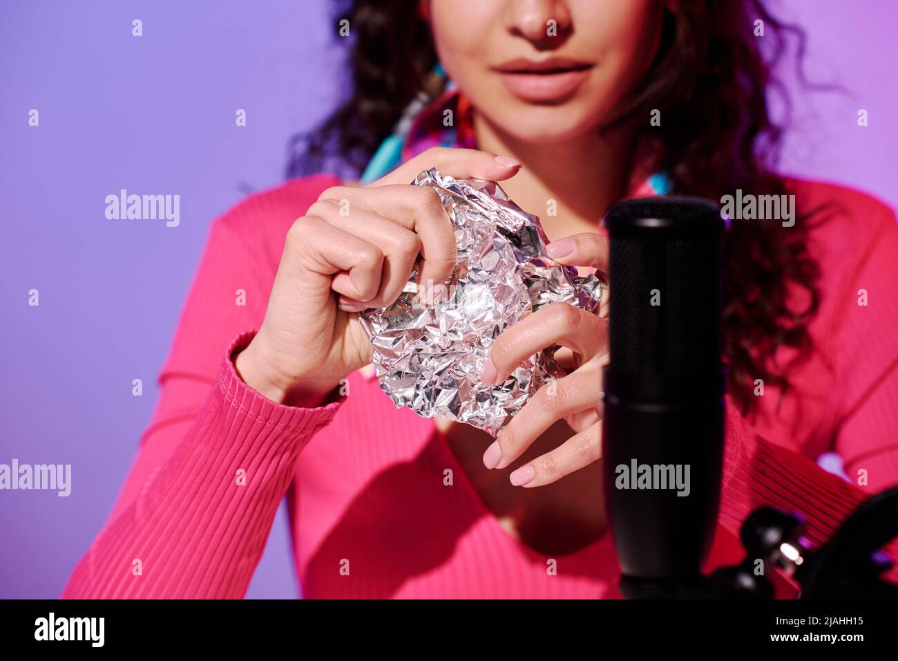 Selective focus of young woman creating content for ASMR blog squeezing ...