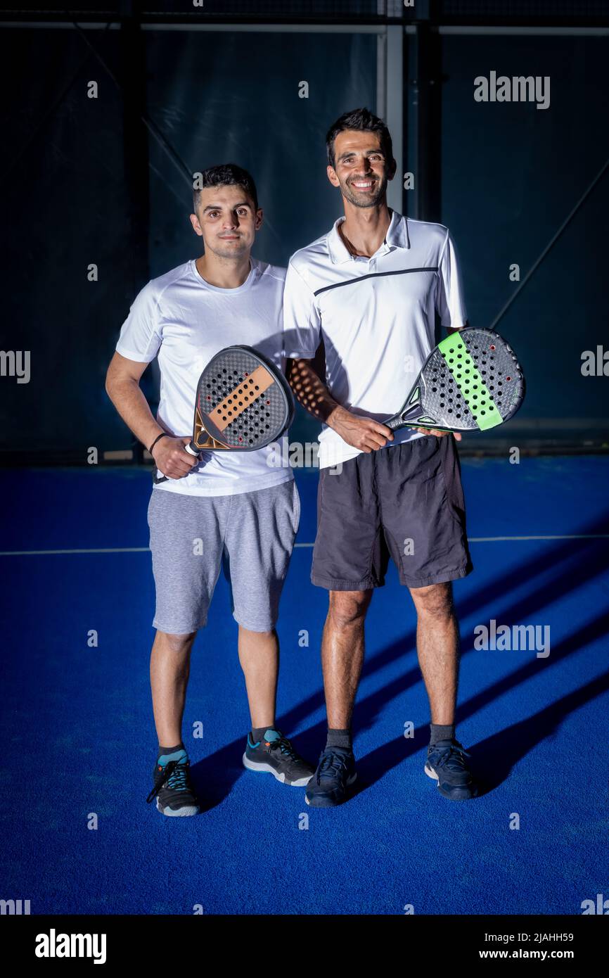 Glad cheerful positive padel players posing on padel court Stock Photo ...
