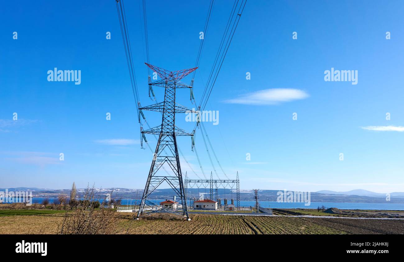 High voltage towers with hanging power lines and power station Stock ...