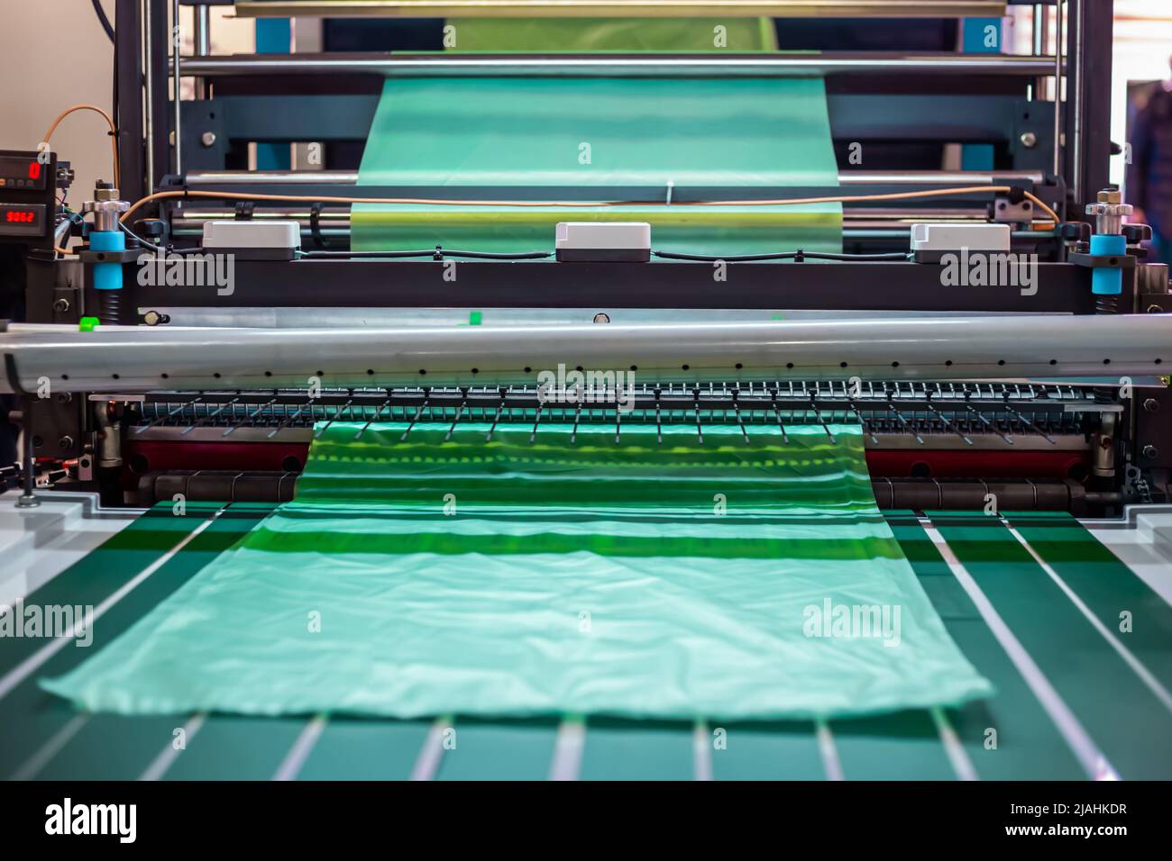 Automatic plastic bag making machine with green polyethylene film Stock ...