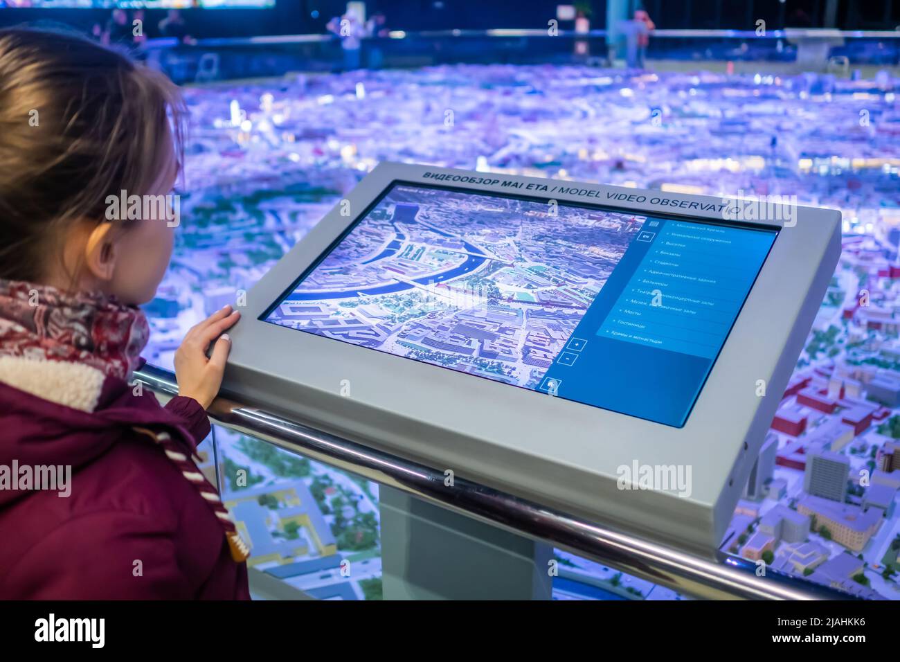 Woman using interactive touchscreen display at modern museum or ...