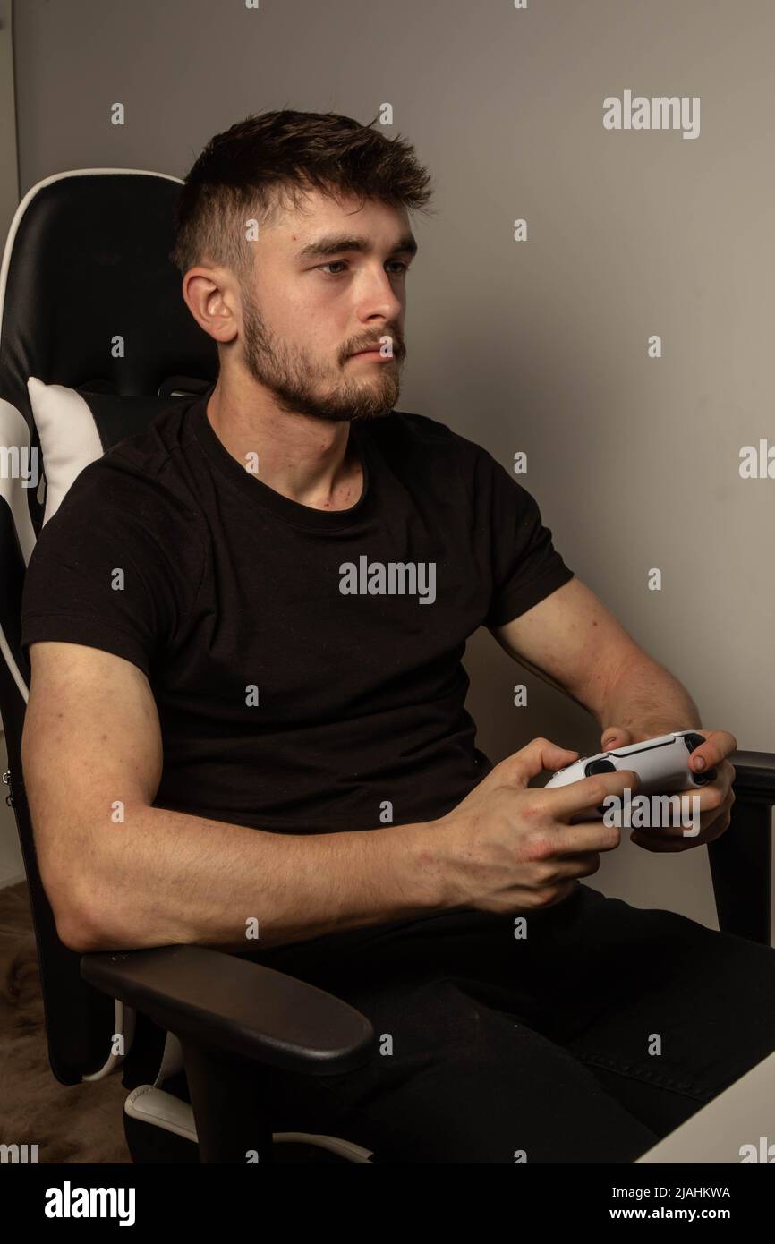 A University Aged Male Student playing a video game Stock Photo - Alamy