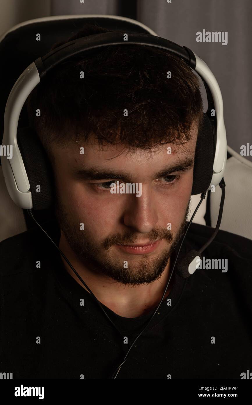A University Aged Male Student playing a video game while wearing a ...