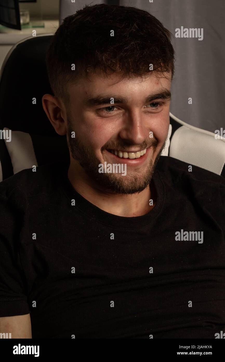 A University Aged Male Student playing a video game Stock Photo - Alamy