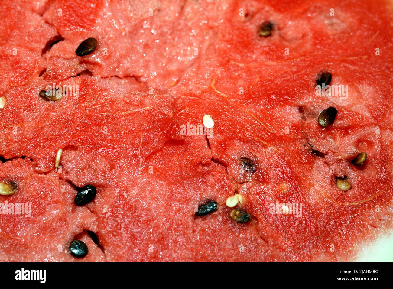 A watermelon fruit cut into a half with seeds and its shell ready to be ...