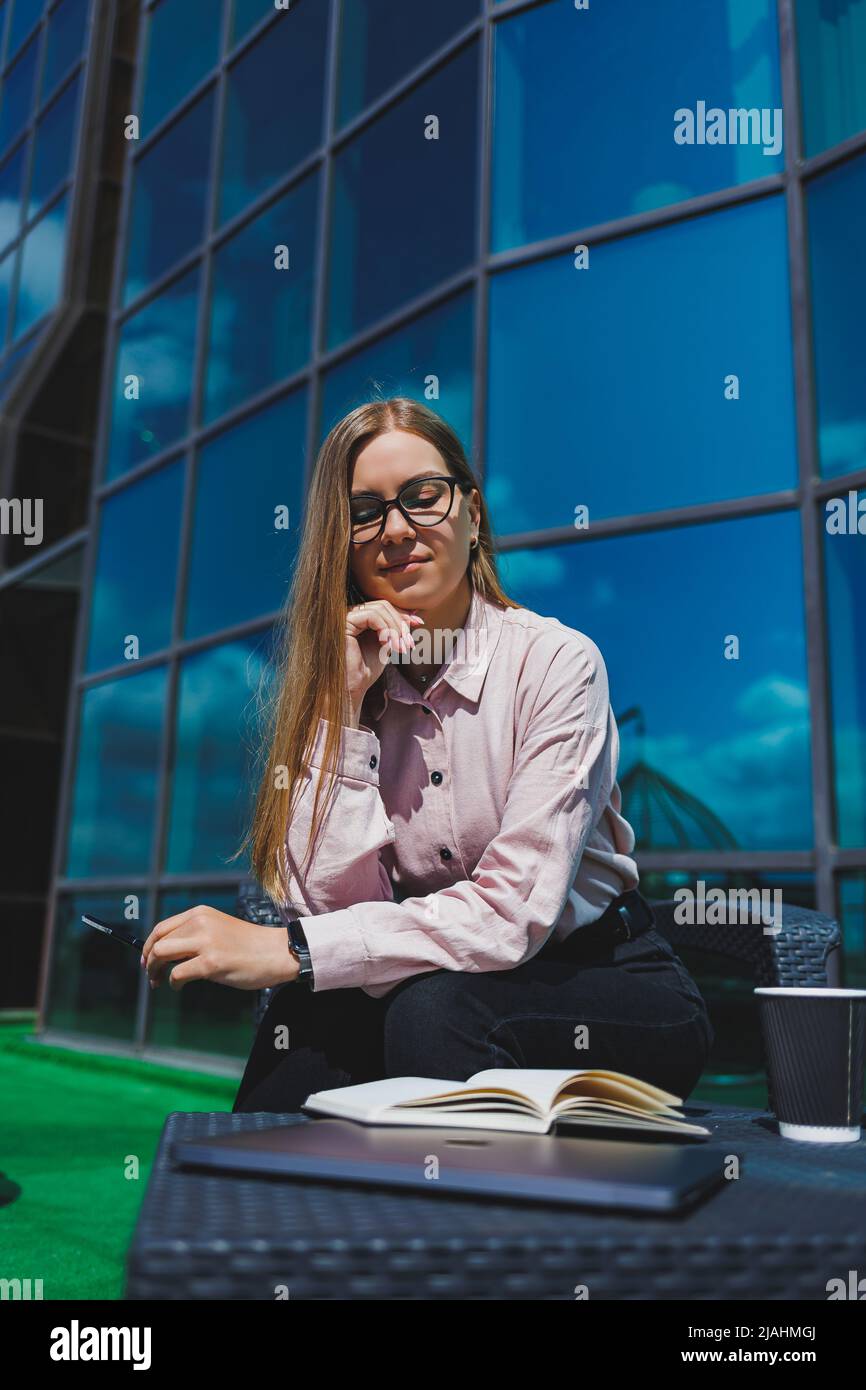 Cheerful female student with notebook for planning study process posing ...