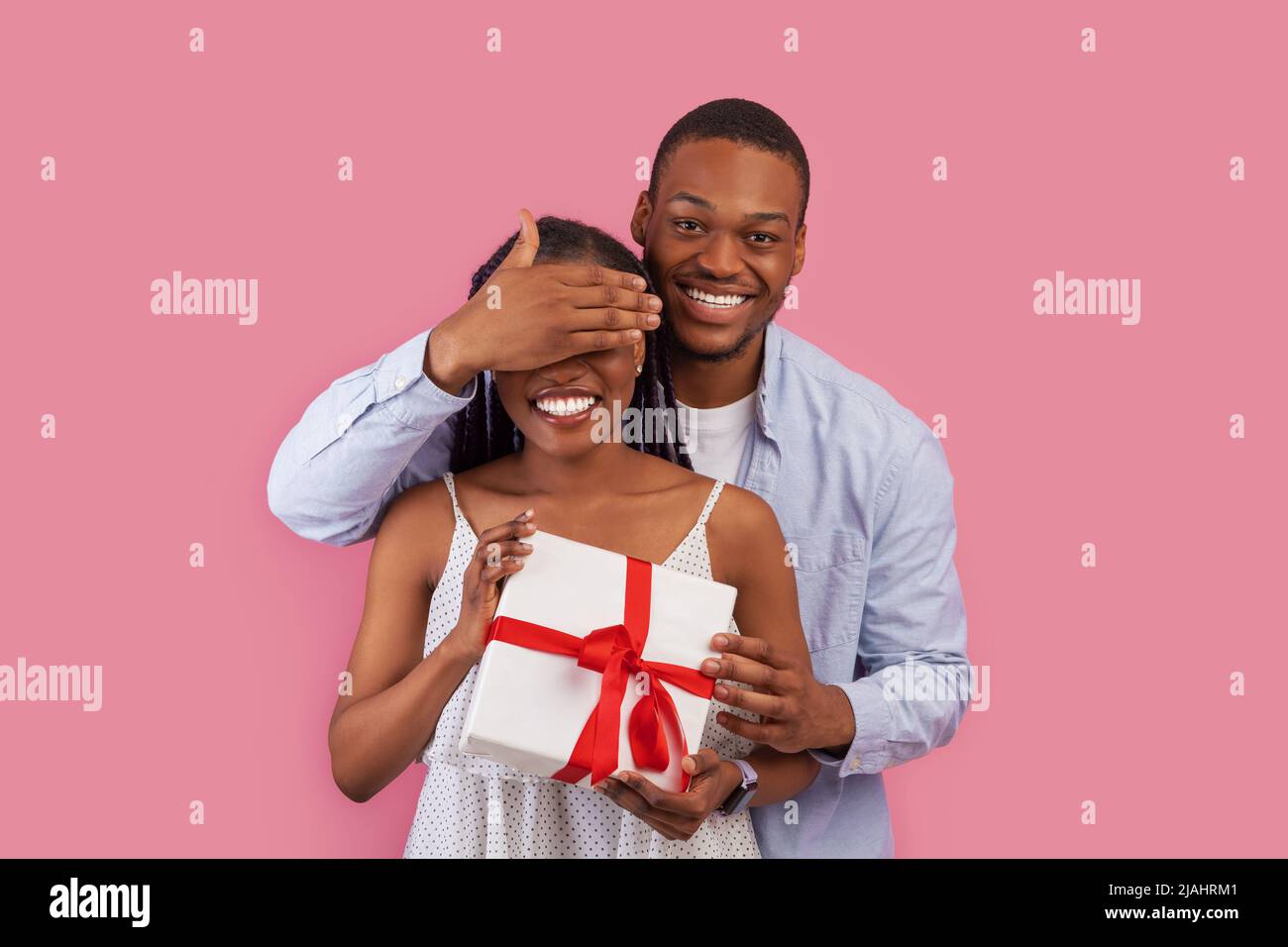 Happy black guy making surprise for his lover giving box Stock Photo ...