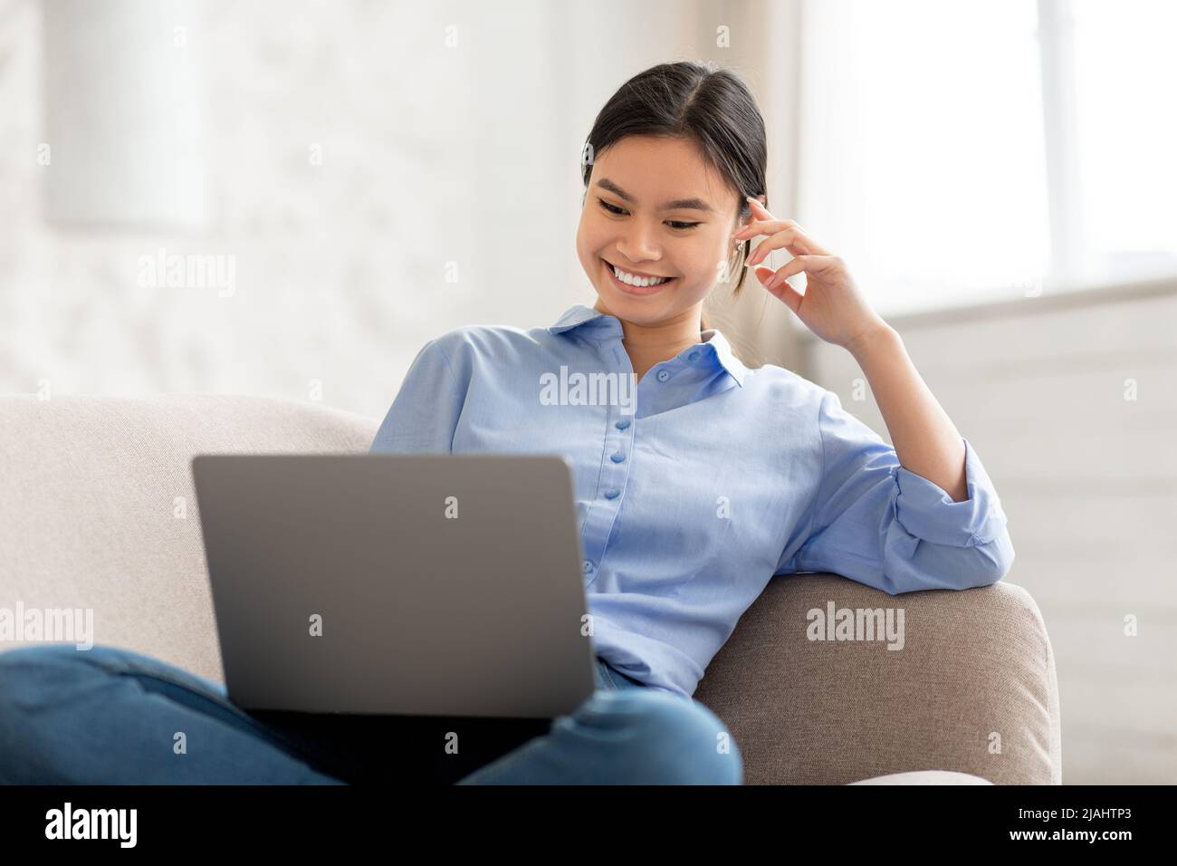 Cheerful korean woman chilling at home, using computer Stock Photo - Alamy