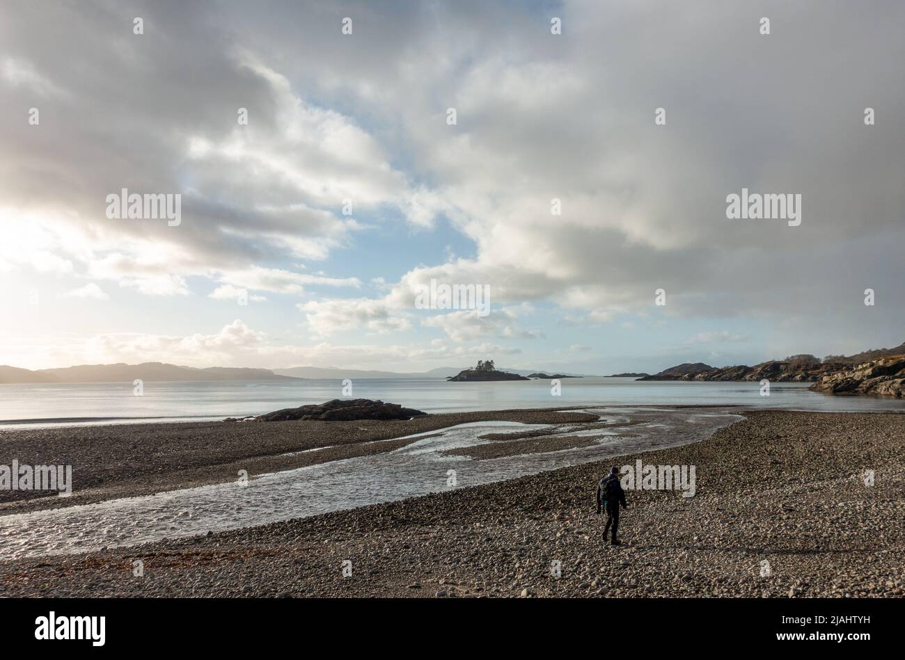 Scottish landscape - person walking on pebble beach at the stunning ...