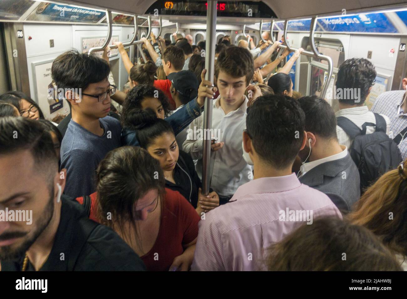 Very crowded F train on its way from Brooklyn to Manhattan during the ...