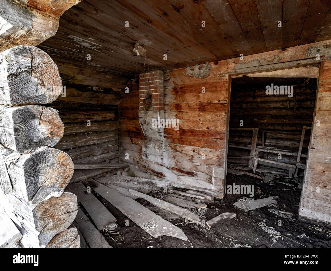 Dirt floor barn with weathered boards and logs Stock Photo - Alamy