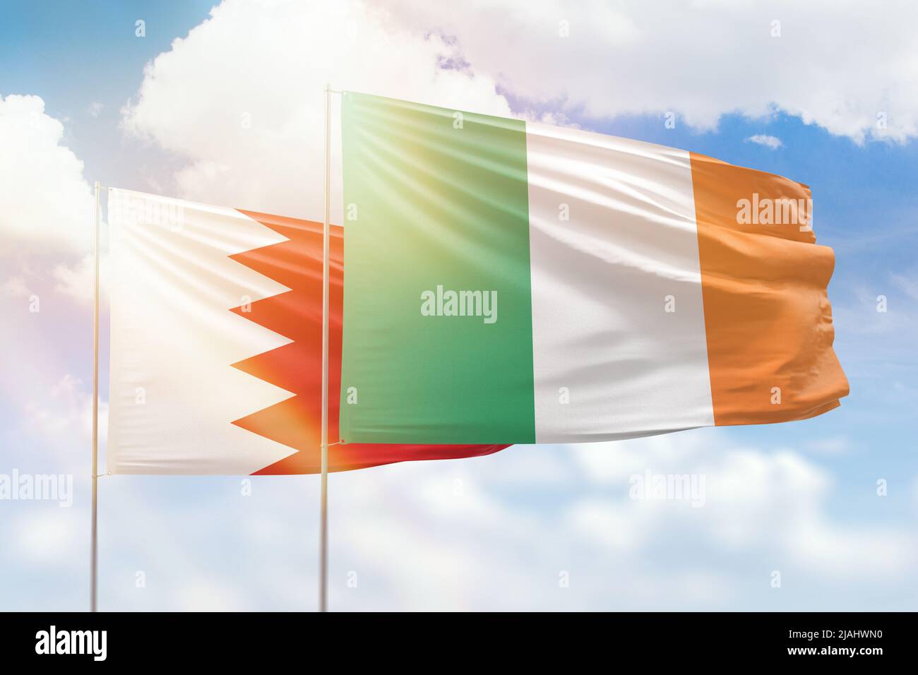 Sunny blue sky and flags of ireland and bahrain Stock Photo - Alamy