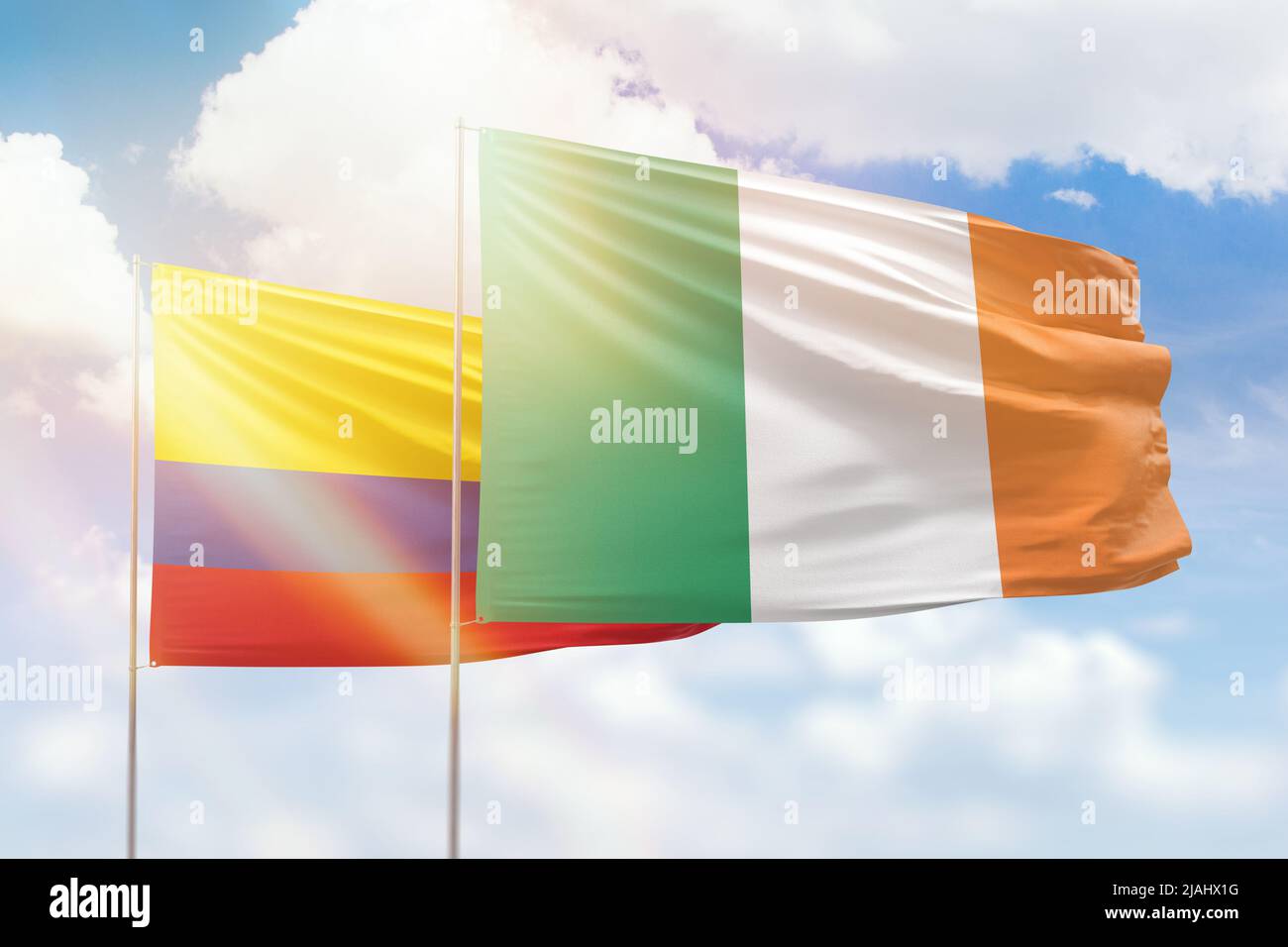 Sunny blue sky and flags of ireland and colombia Stock Photo - Alamy