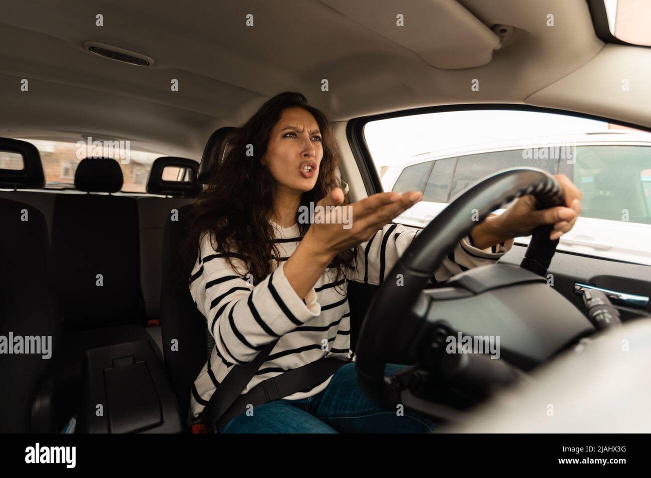 Angry woman driving car shouting at somebody Stock Photo - Alamy