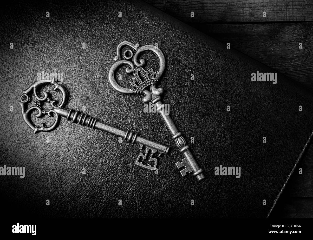 Old key on a dark background, texture of the skin. Black and white ...