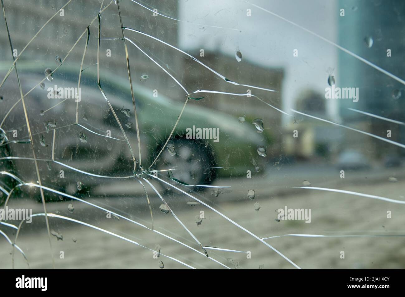 View of city and people through cracked glass. City as habitat with ...