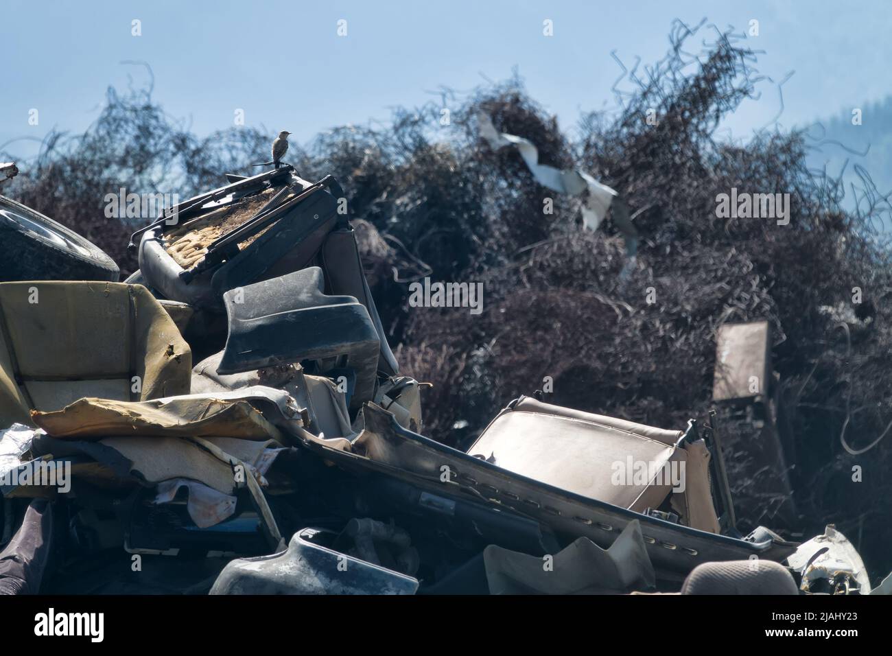 A mountain of scrap metal in the mountains. Pollution of nature by ...