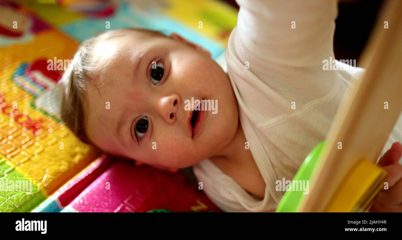 Baby hands holding play toy, close-up infant plays with child ...